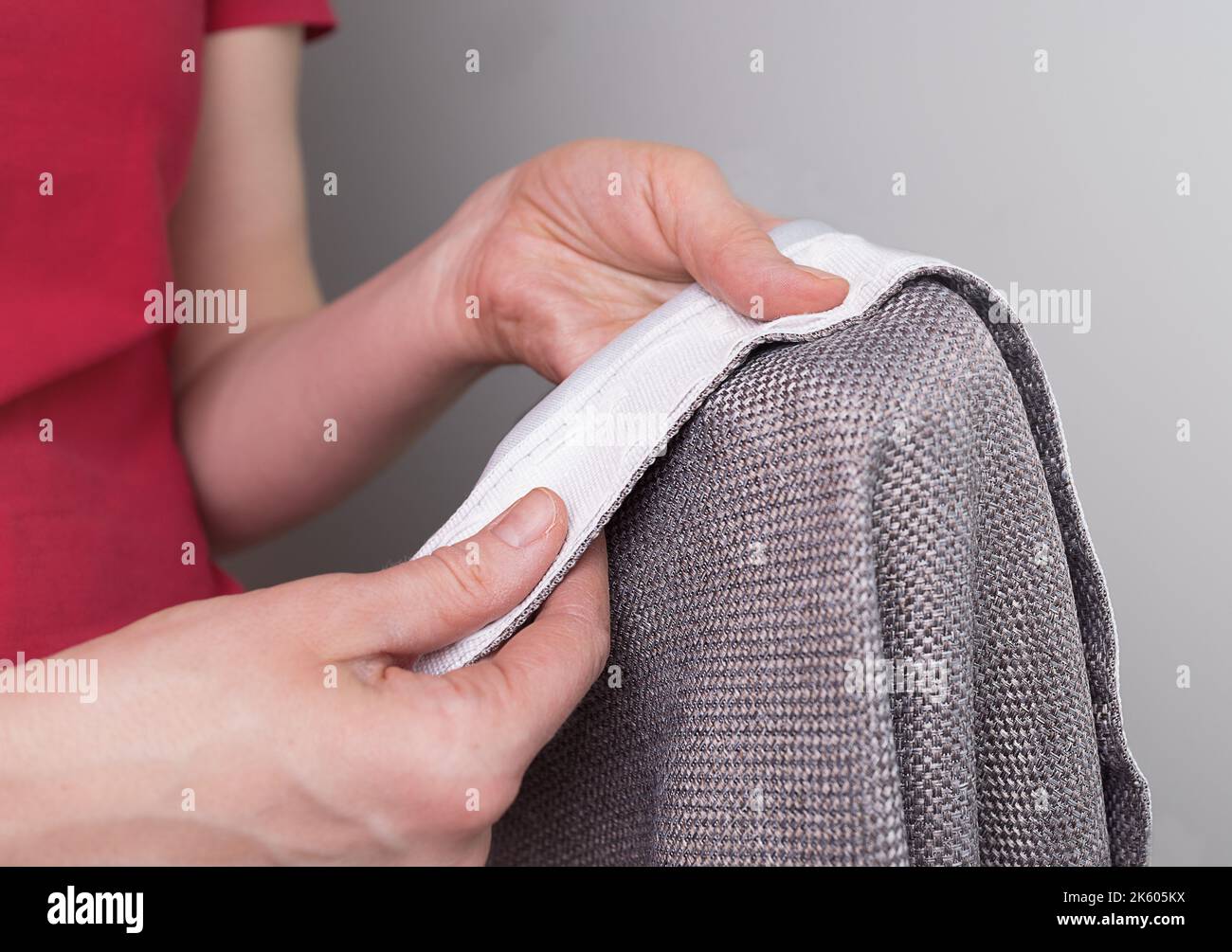 close-up, woman's hands show how to decorate the curtains in the house ...