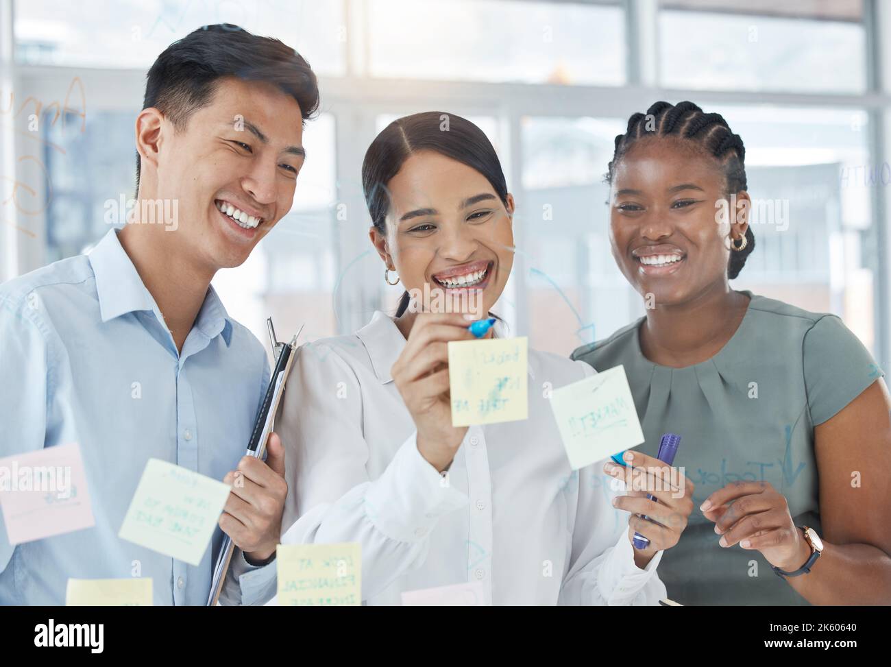 Teamwork, planning and sticky note meeting with business people writing ...