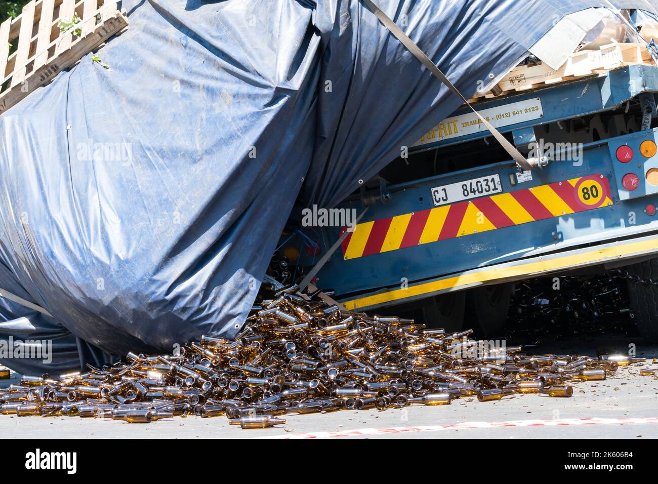 jackknifed truck and load spilling over onto the road or tarmac concept ...