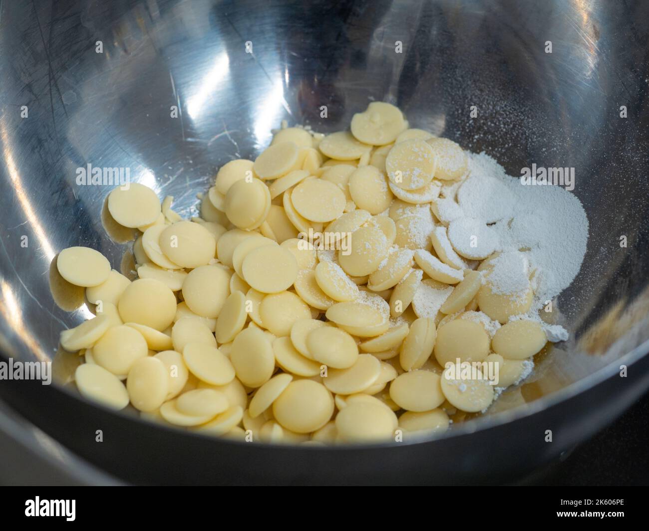 white chocolate drops for cake topping Stock Photo - Alamy