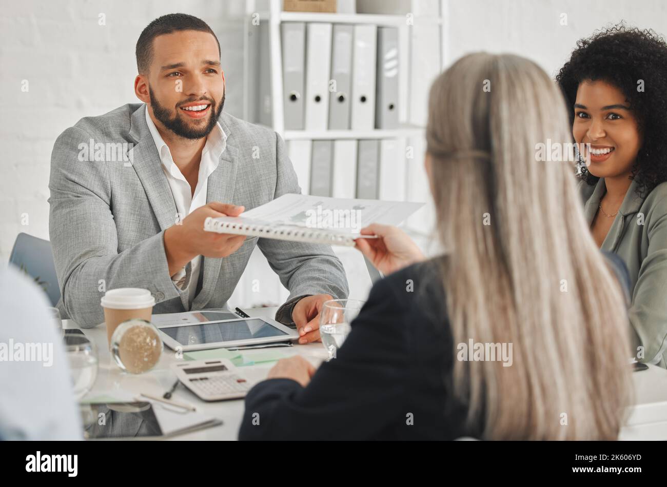 Young happy mixed race businessman giving a report to a female ...