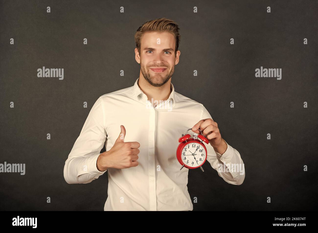 Happy manager give thumbs up holding clock. Time management Stock Photo ...