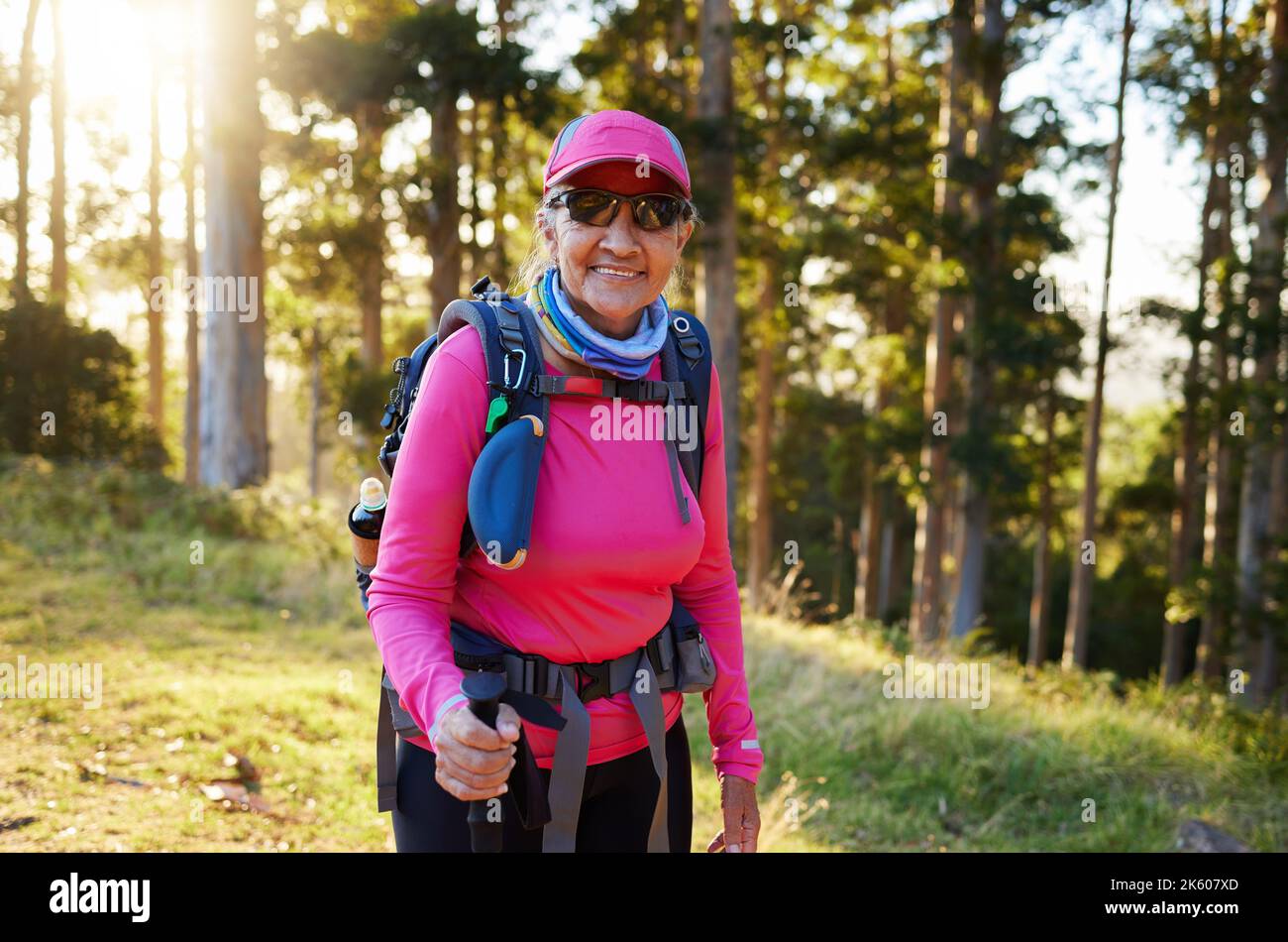 Hiking, nature and summer with a senior woman in the forest or woods ...