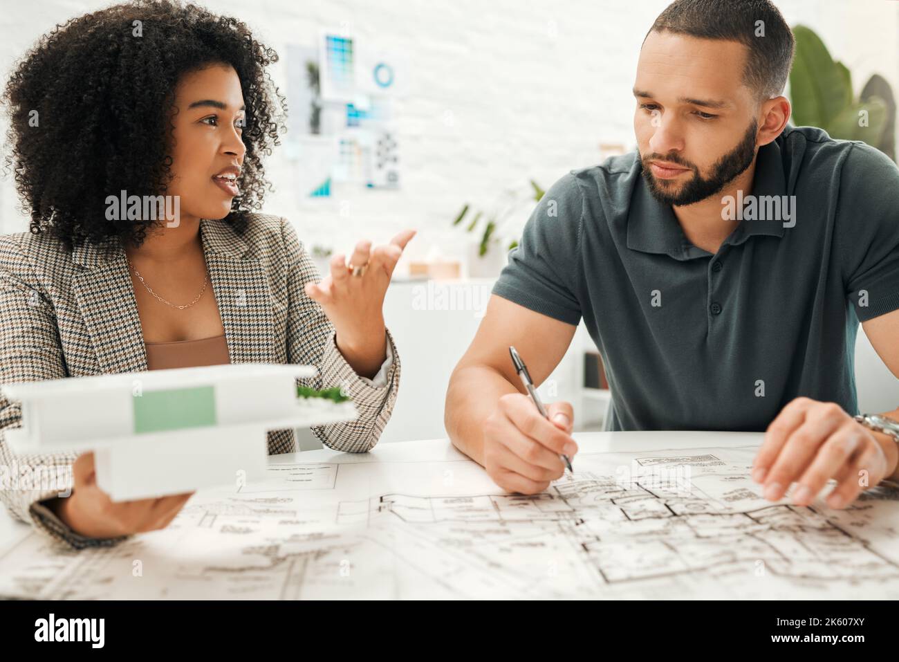 Two architectural coworkers planning a building project. Young ...