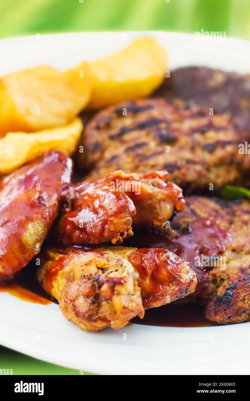 Mixed grilled meats on a plate (selective focus Stock Photo - Alamy