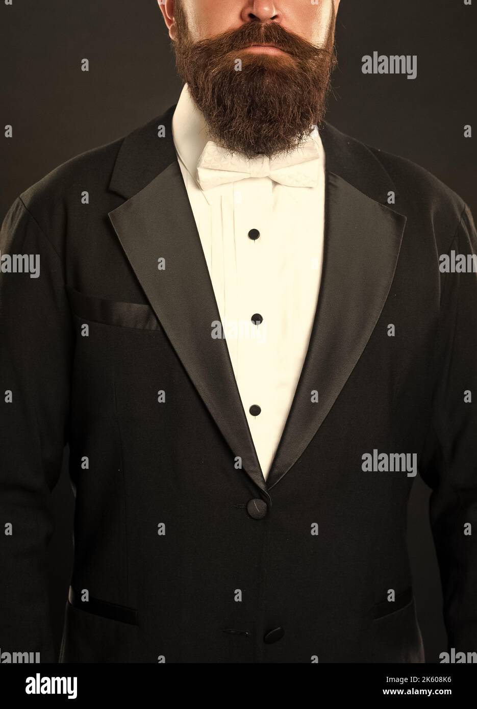 cropped bearded businessman in tuxedo on black background, formalwear ...