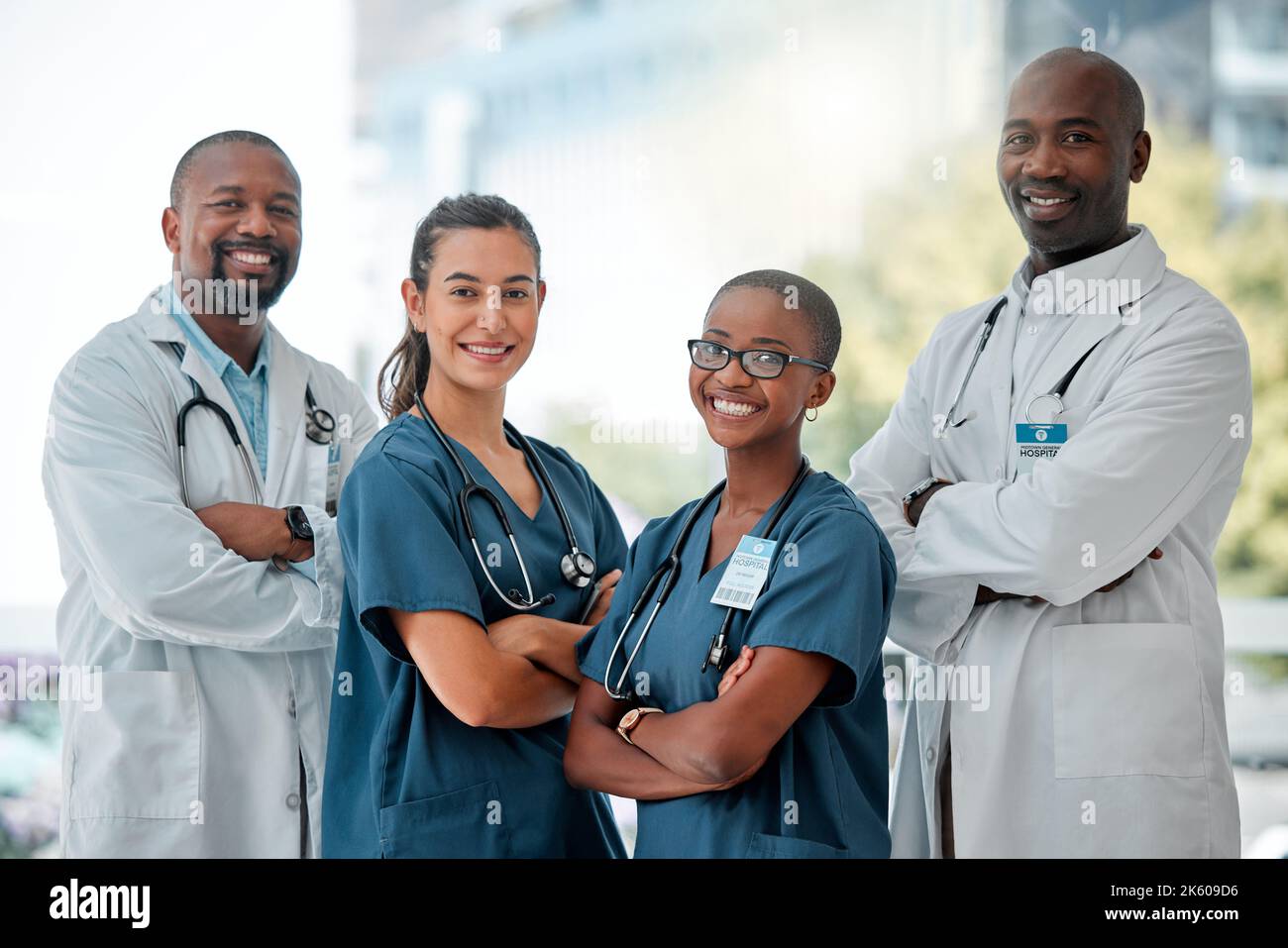 Group of happy diverse doctors and nurses standing in a line with their ...