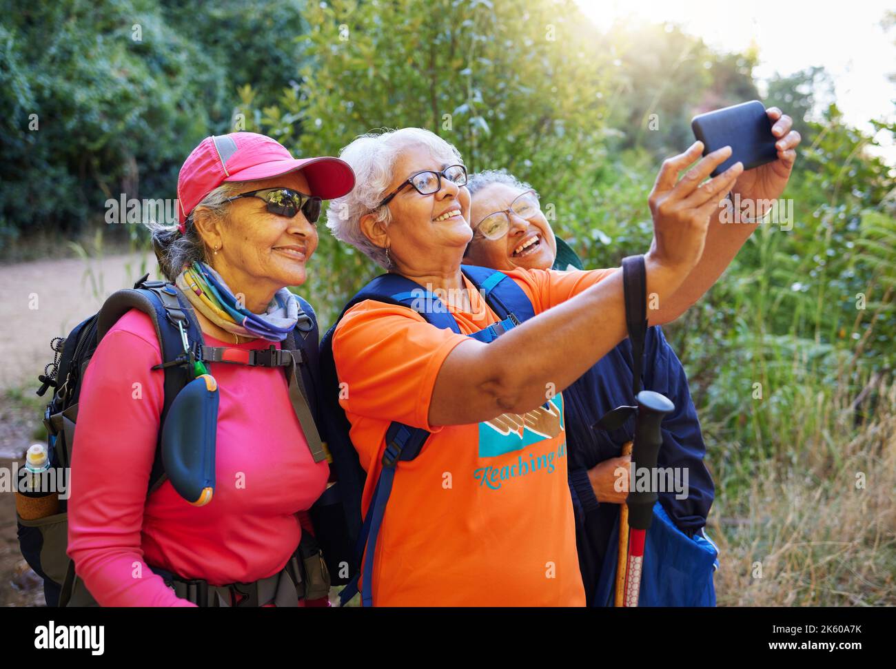 Senior women, phone selfie and hiking in nature on holiday or summer ...
