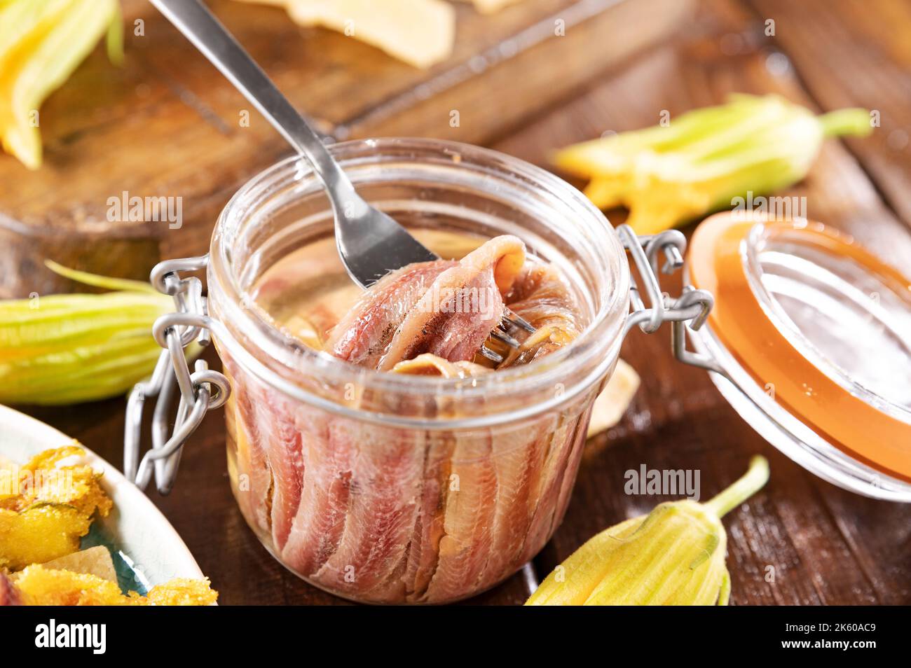 Anchovies in a jar, on a wooden rustic background. Traditional italian ...
