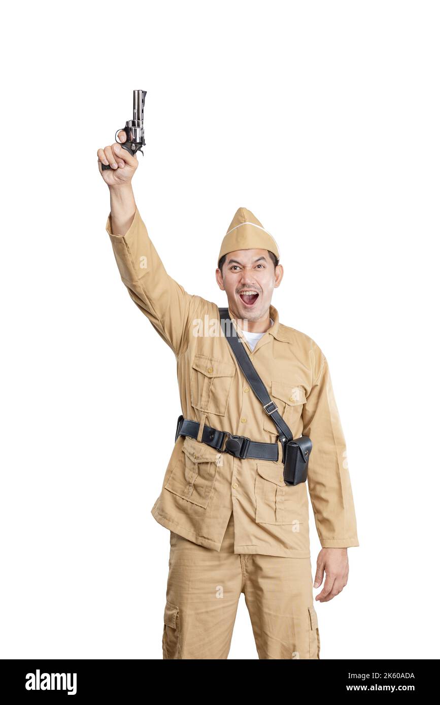 Indonesian freedom fighter standing while holding gun isolated over ...