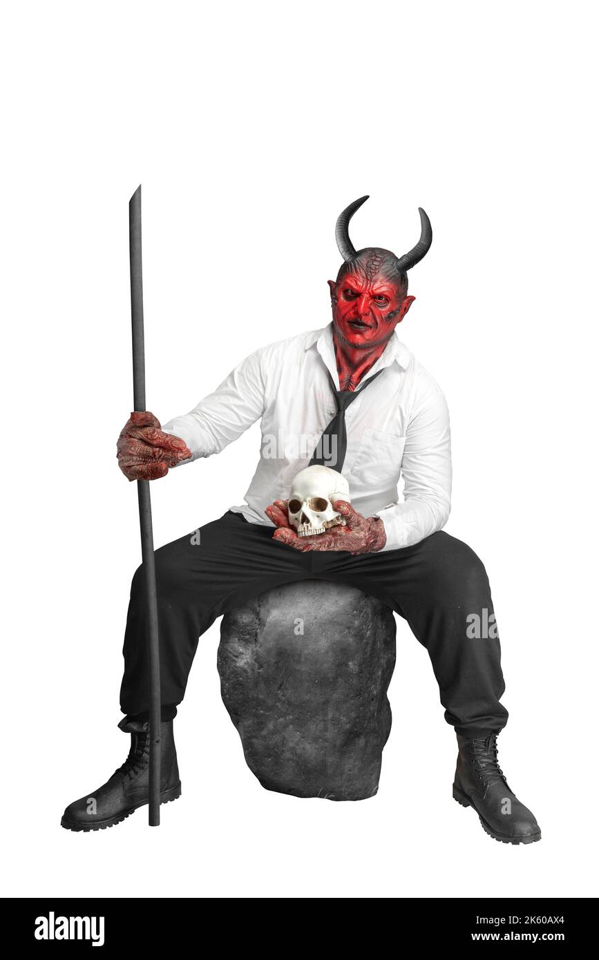 Devilman is holding a stick and a human skull head isolated over white ...