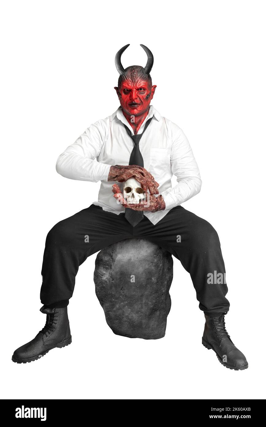 Devilman is holding a human skull head isolated over white background ...