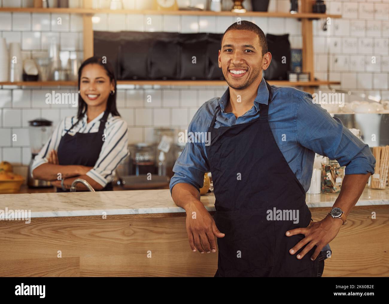 Two business partners together in their coffeeshop. Young couple ...