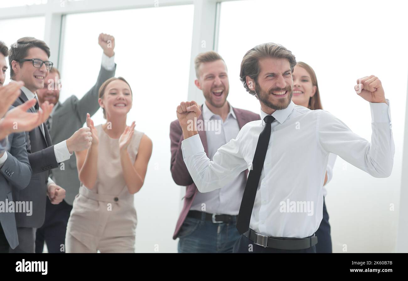 corporate group of employees congratulating each other on the victory ...