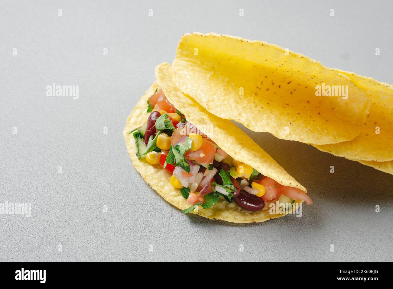 Homemade vegan tacos with black beans, corn and vegetables. The concept ...