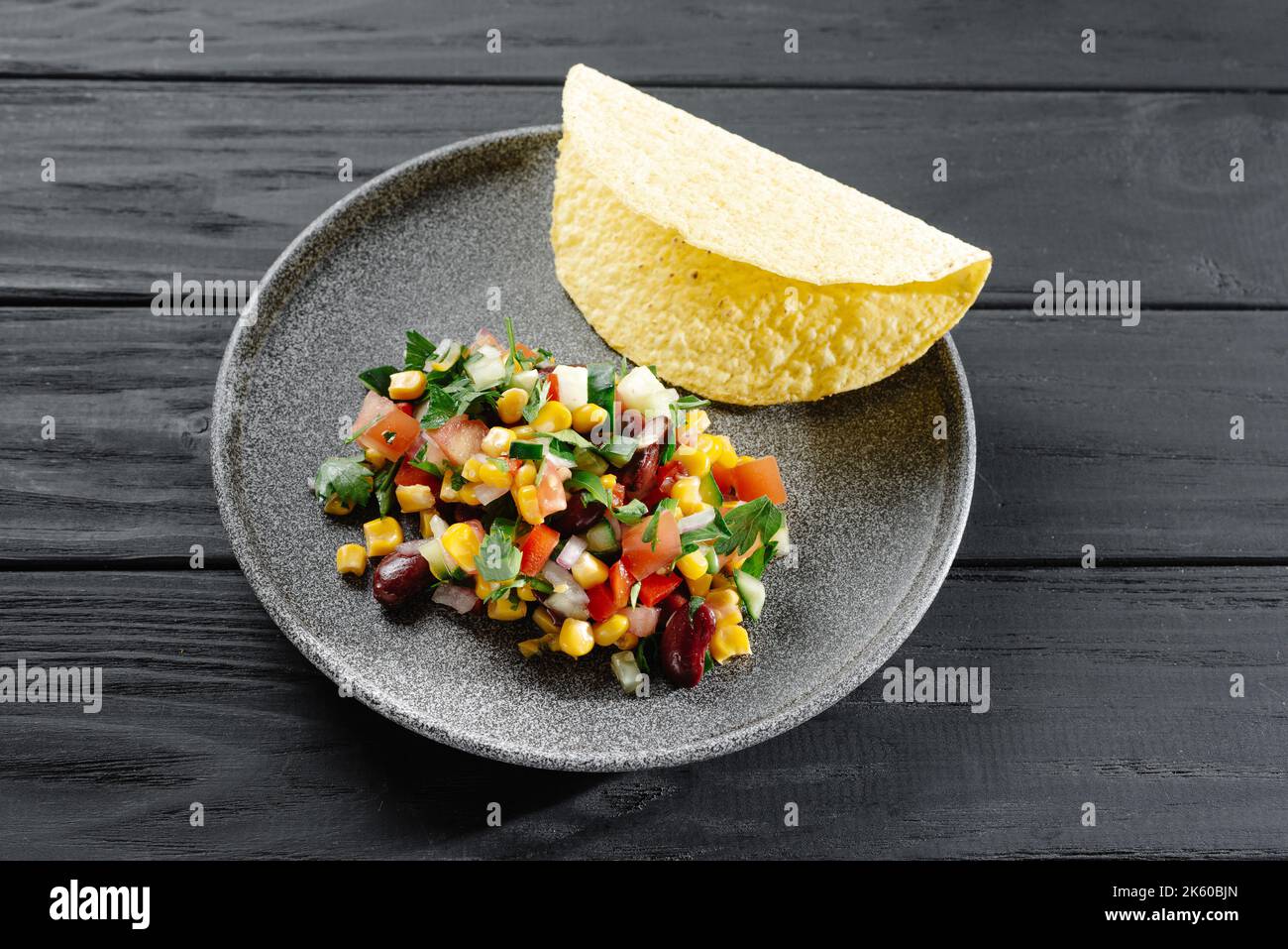 Salsa with corn and beans on a wooden backdrop with tacos. Mexican ...