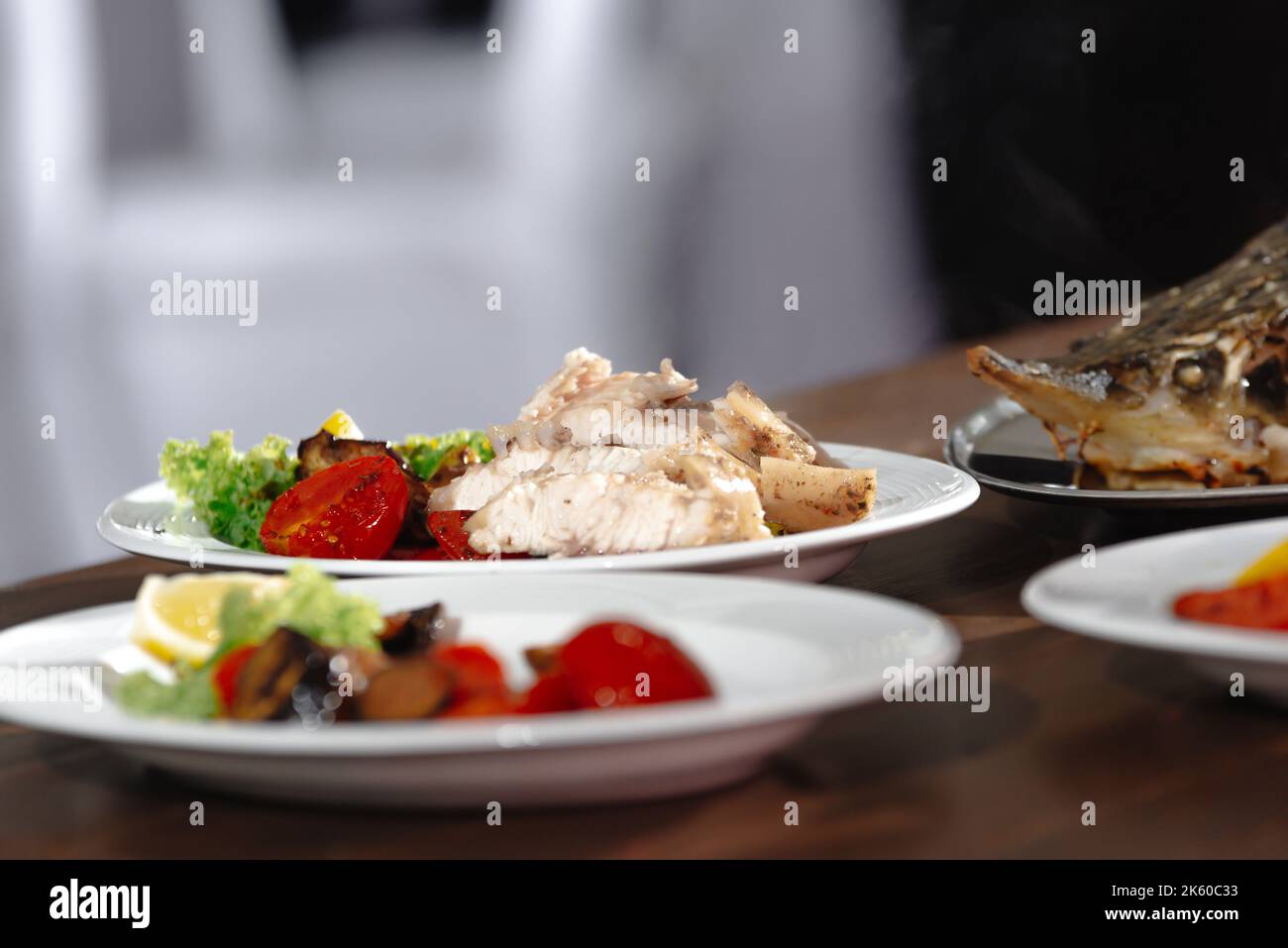fish slices on plates. Cooked fish sturgeon baked Stock Photo - Alamy