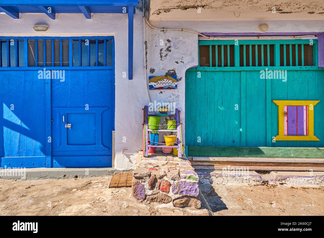 Colorful blue, green boat garage doors, Klima fishermen village, Greece ...