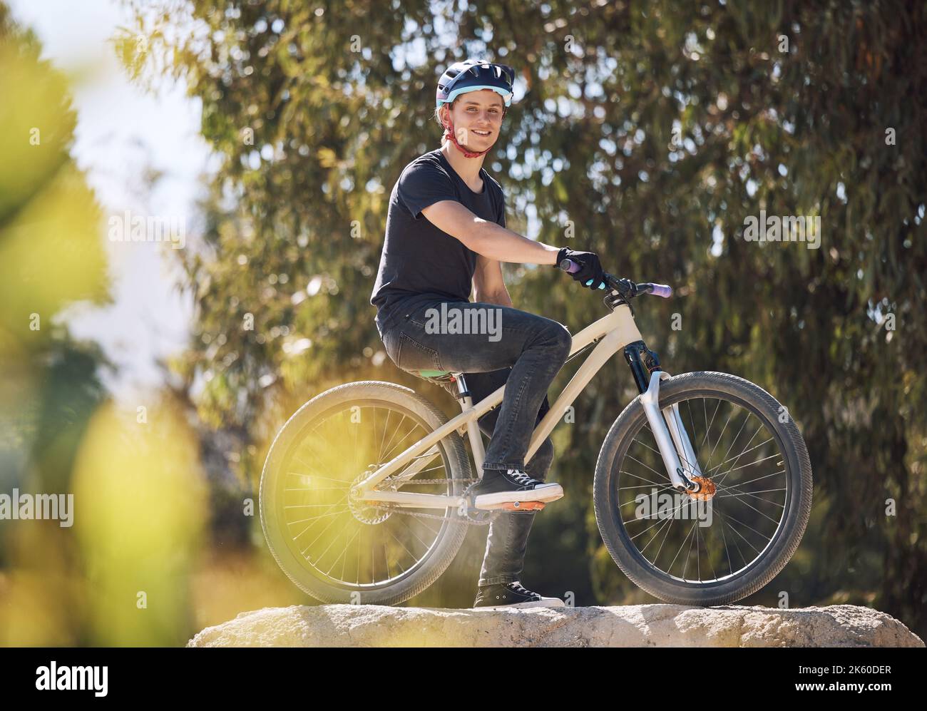 Portrait of a handsome man wearing a helmet and taking a break from ...