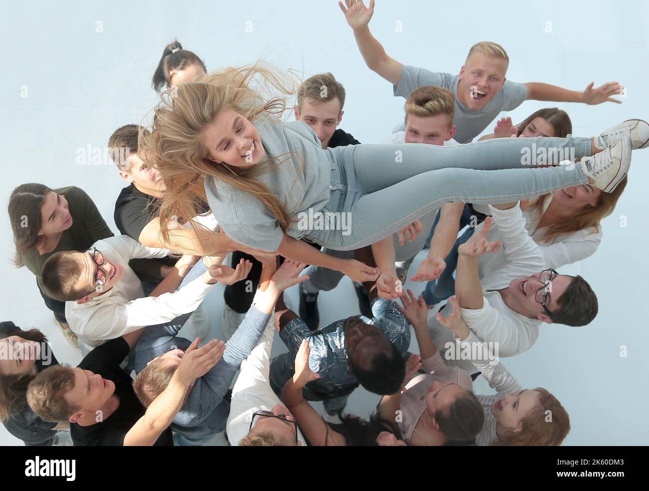 happy team of young people rocking their leader Stock Photo - Alamy