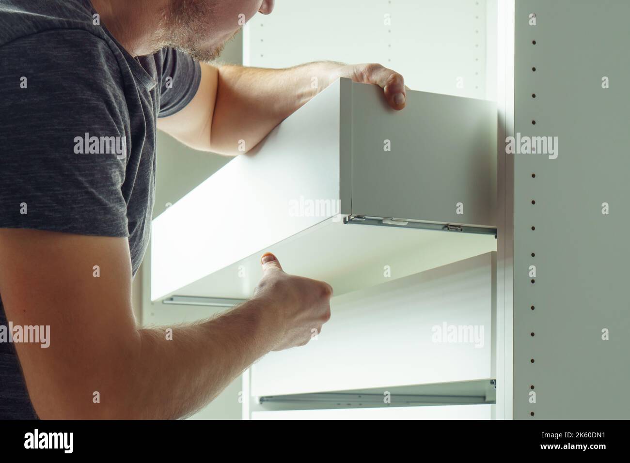 Handyman fixing wardrobe hi-res stock photography and images - Alamy