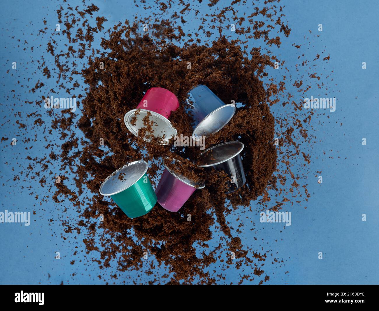Coffee capsules among coffee powder explosion Stock Photo - Alamy