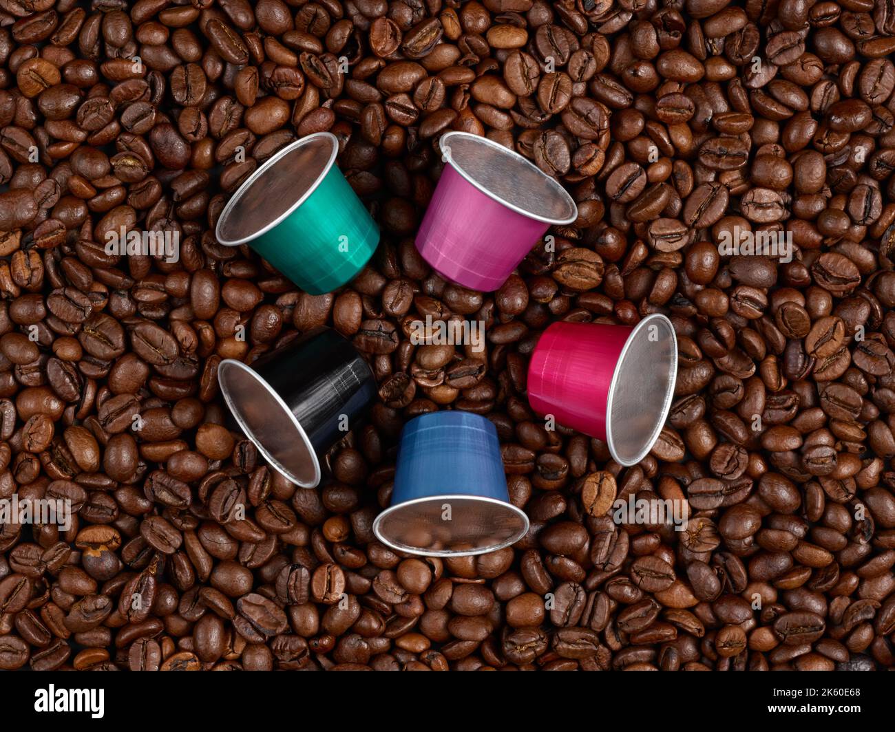 Five coffee capsules on a heap of coffee beans Stock Photo - Alamy