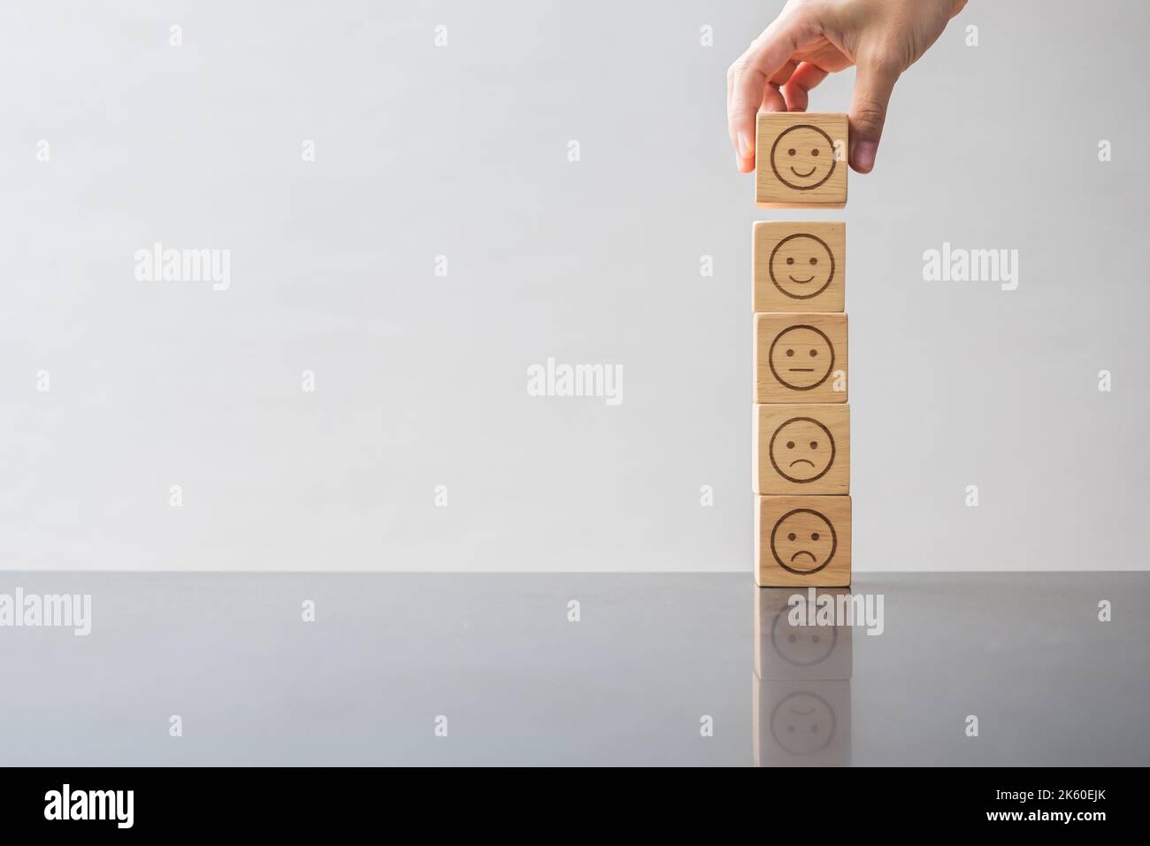 Man hand holding emotion face block. Customer choose Emoticon for user ...