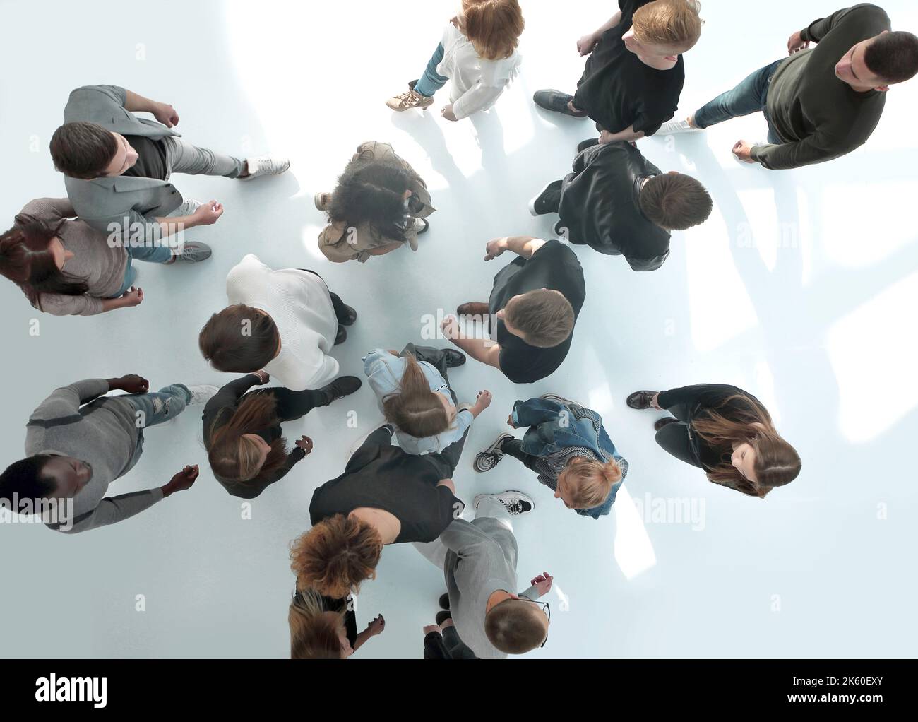 top view .groups of diverse young people moving towards each other ...