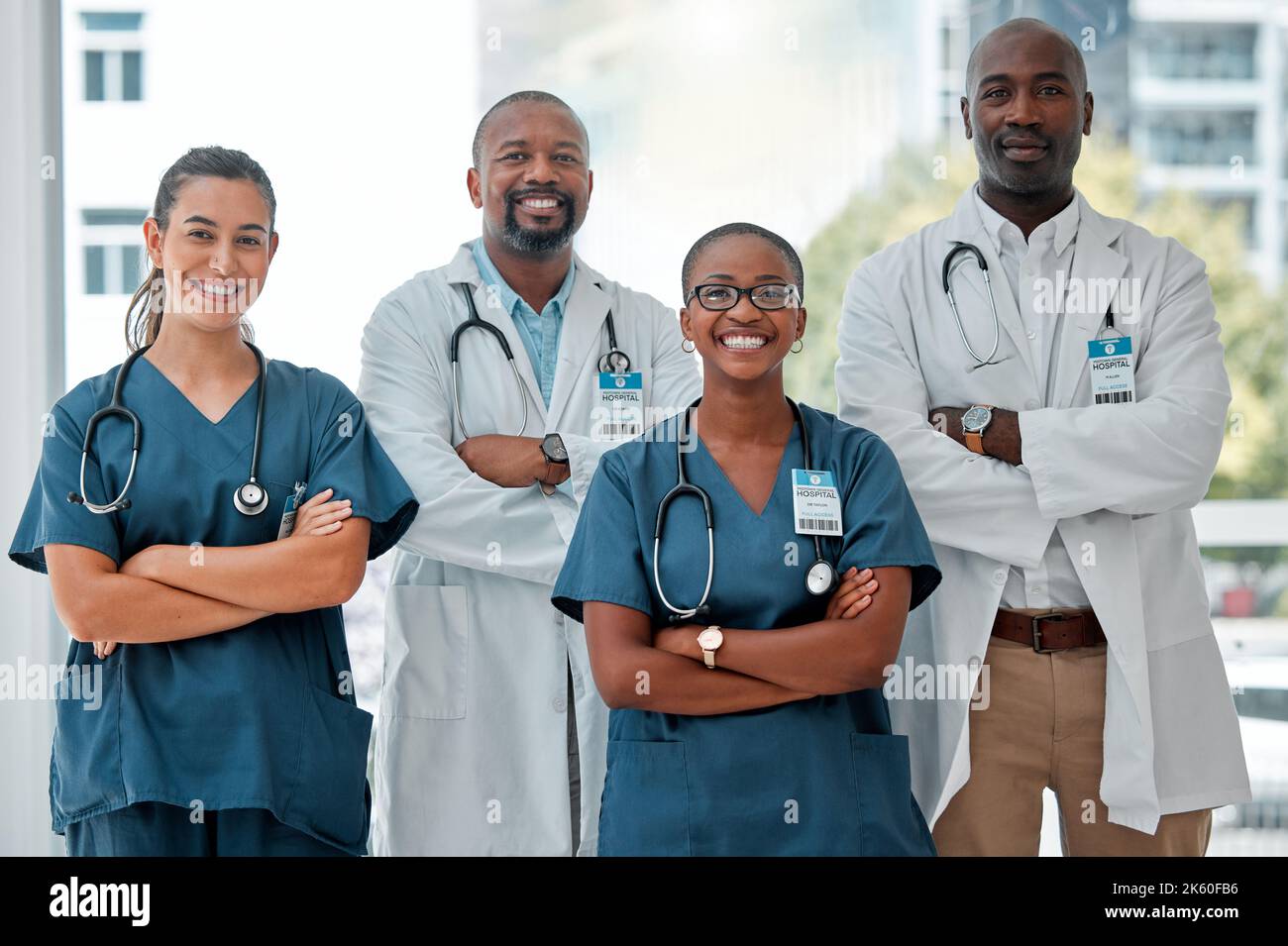 Group of happy diverse doctors and nurses standing in a line with their ...
