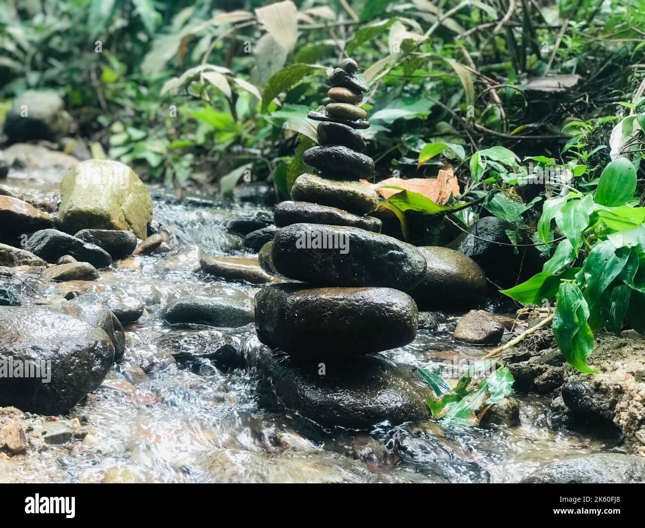 A closeup of beautiful wet stones stacked on top of each other in a ...