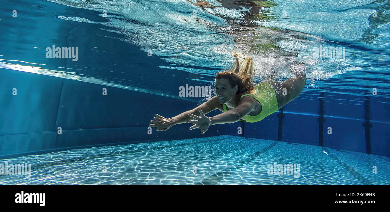 Woman dives underwater in the swimming pool Stock Photo - Alamy