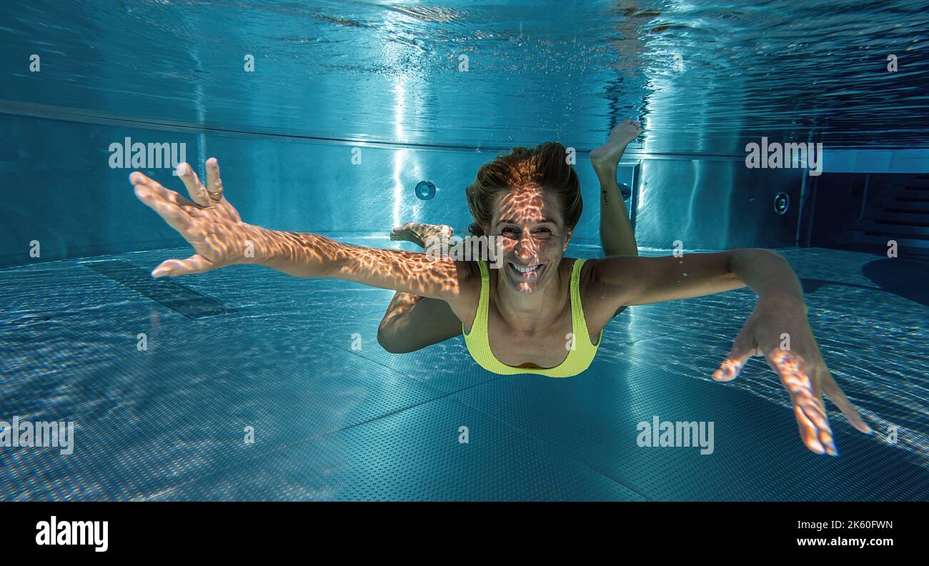Young lady swimming underwater in the pool Stock Photo - Alamy
