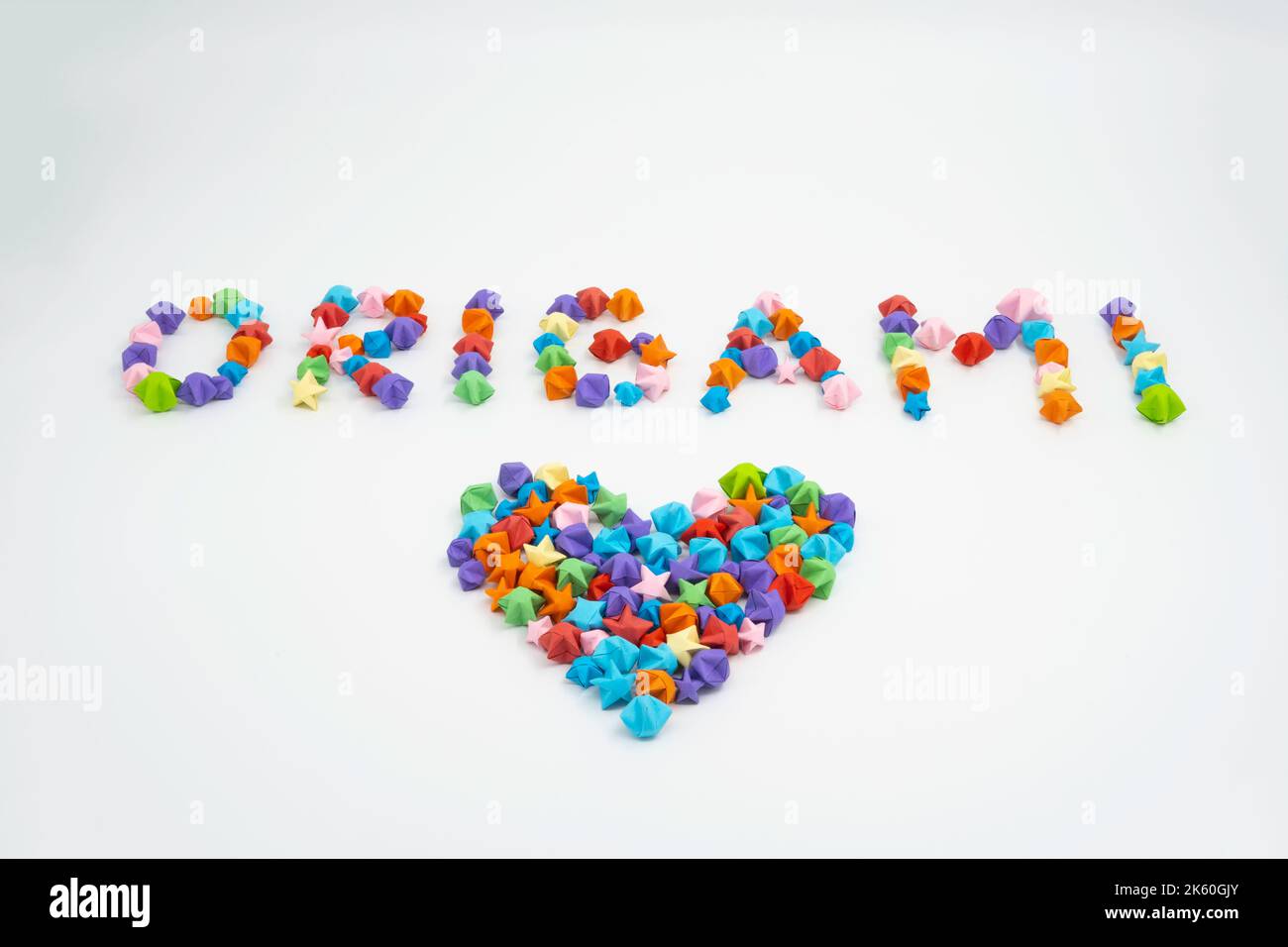 Origami sign and heart creative concept made of bunch of multi colored ...