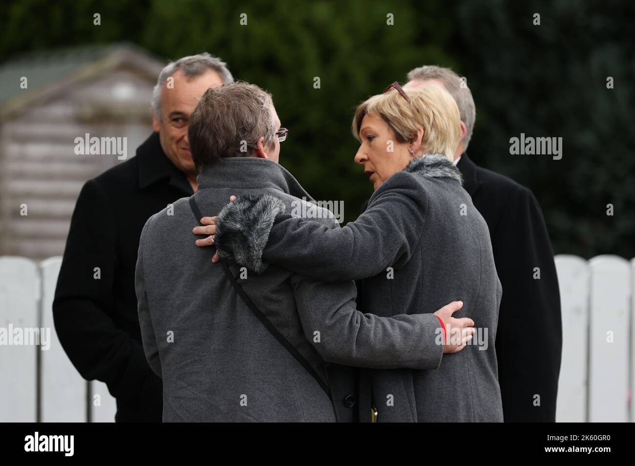 Mourners comfort each other as they arrive at St Michael's Church ...