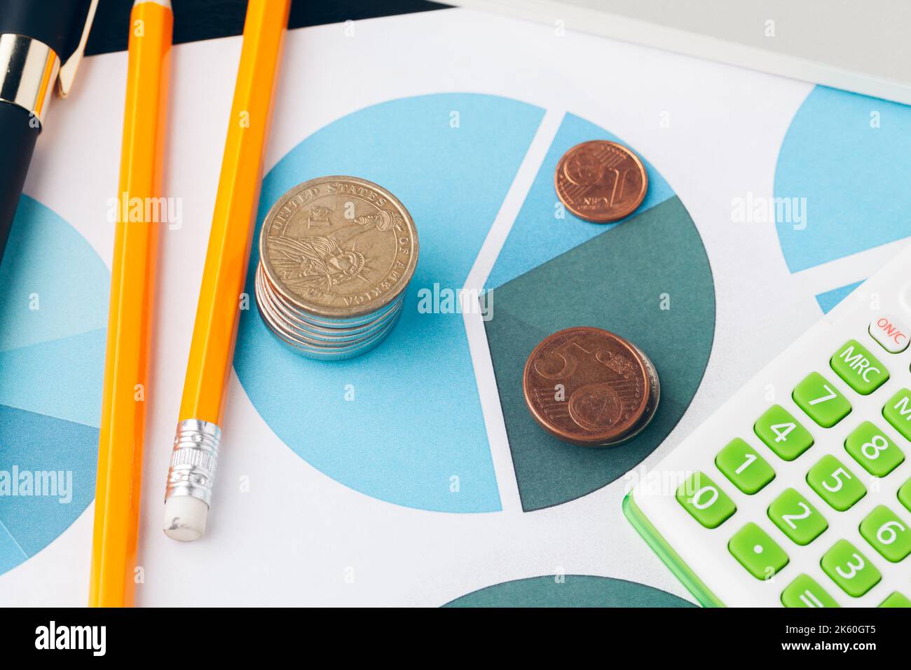 pile of money coins with graph paper on wood table, concept in account ...