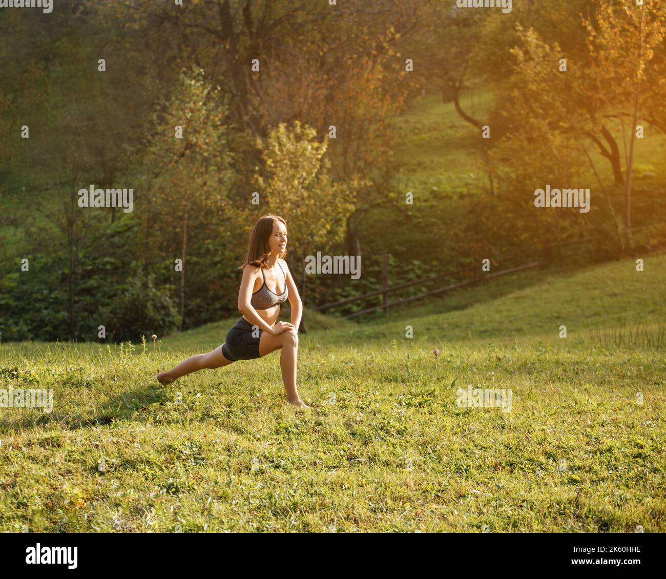 Yoga outdoor. Happy athletic woman with outstretched arms practicing ...