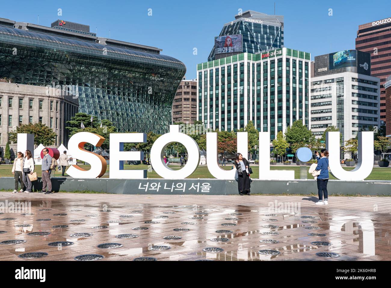 Tourists take photos in front of "I Seoul U" board at Seoul Plaza in ...