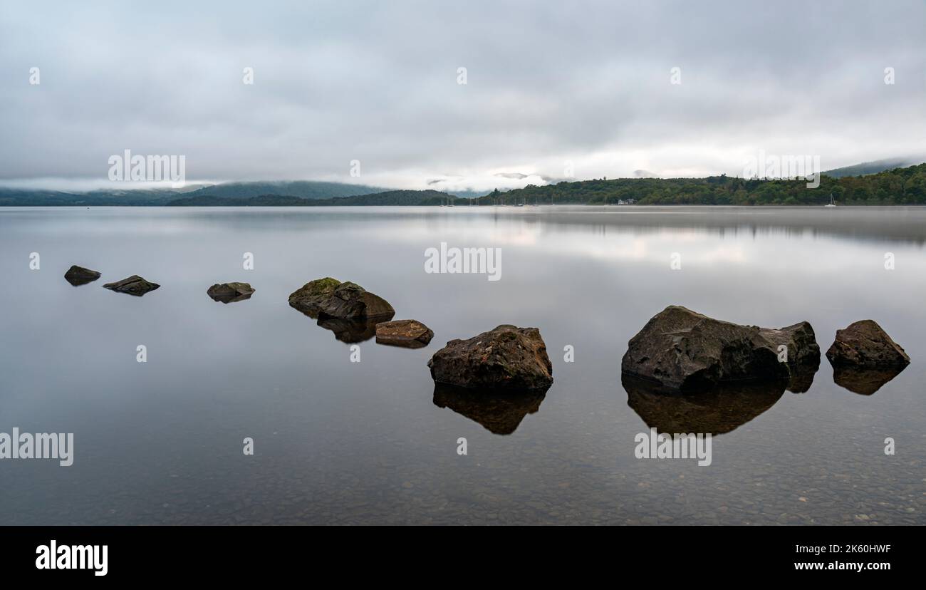Rocks in the calm waters of loch Lomond at Milarrochy Bay Stock Photo ...