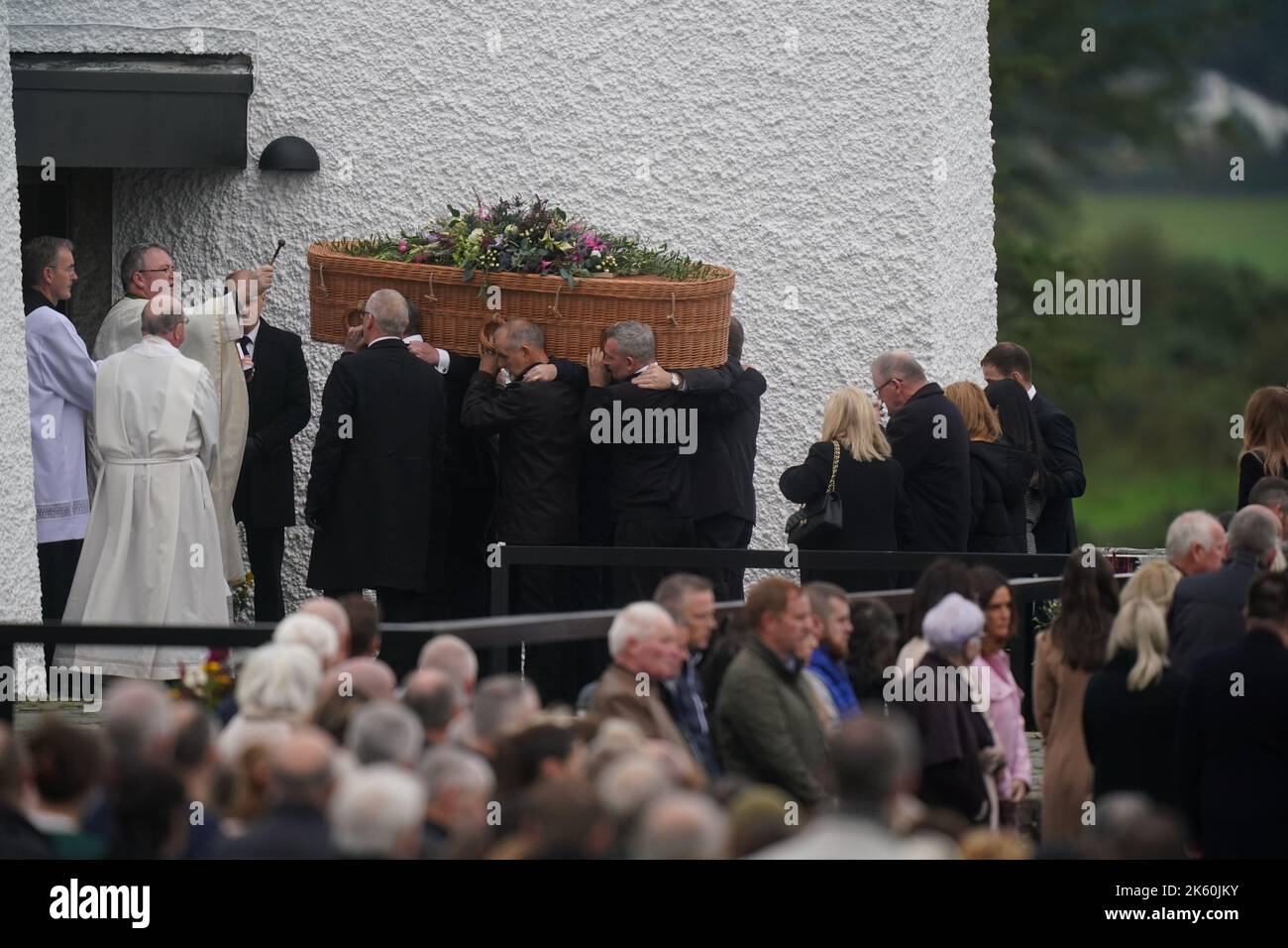 Priest Fr John Joe Duffy sprinkles holy water on the coffin of Jessica ...