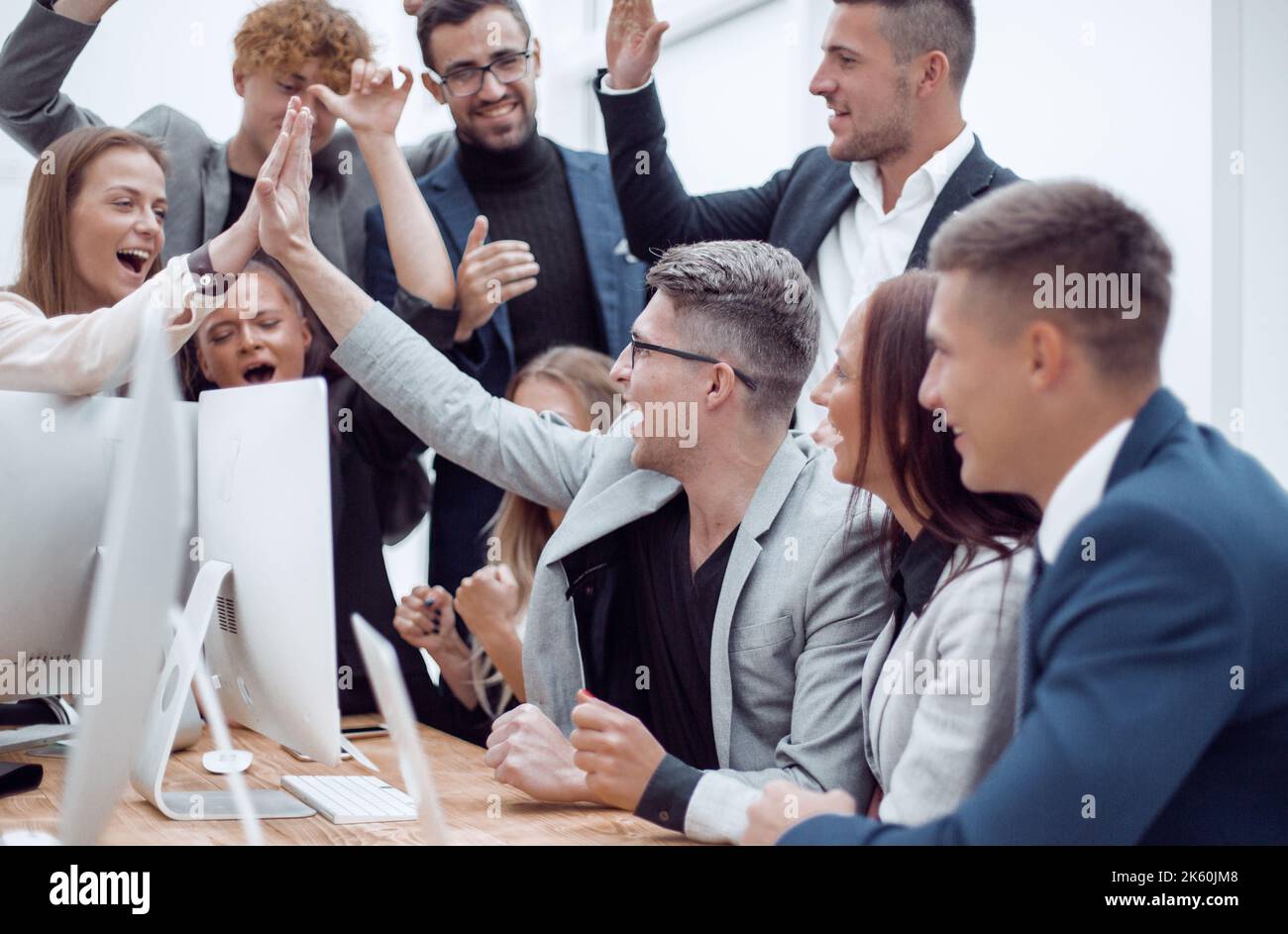 happy business team cheering near the desktop Stock Photo - Alamy