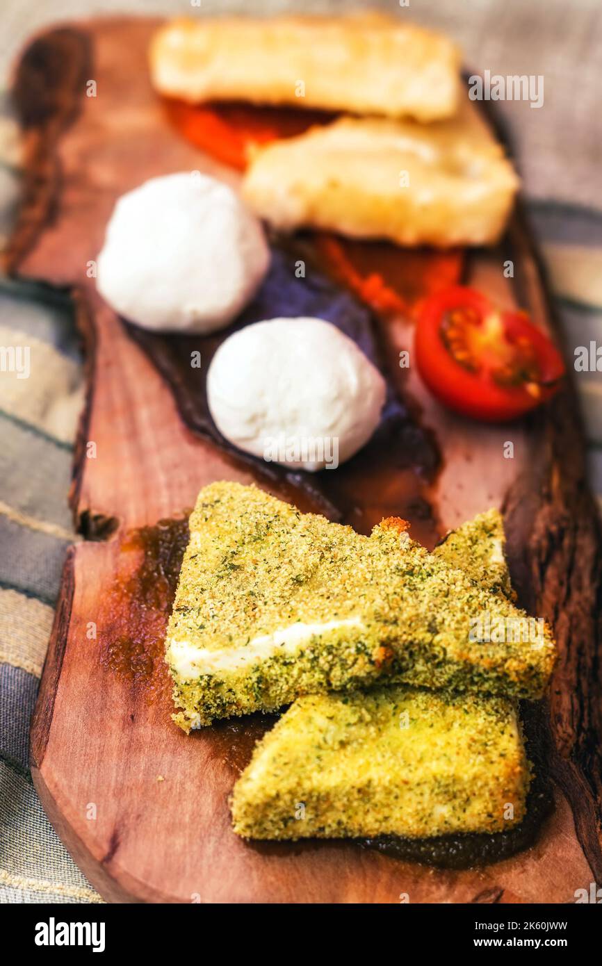 Rustic Cretan cheese board with local cheeses and jam (selective focus ...