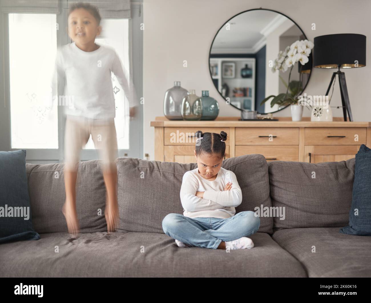 Two young mixed race siblings showing their different personalities ...