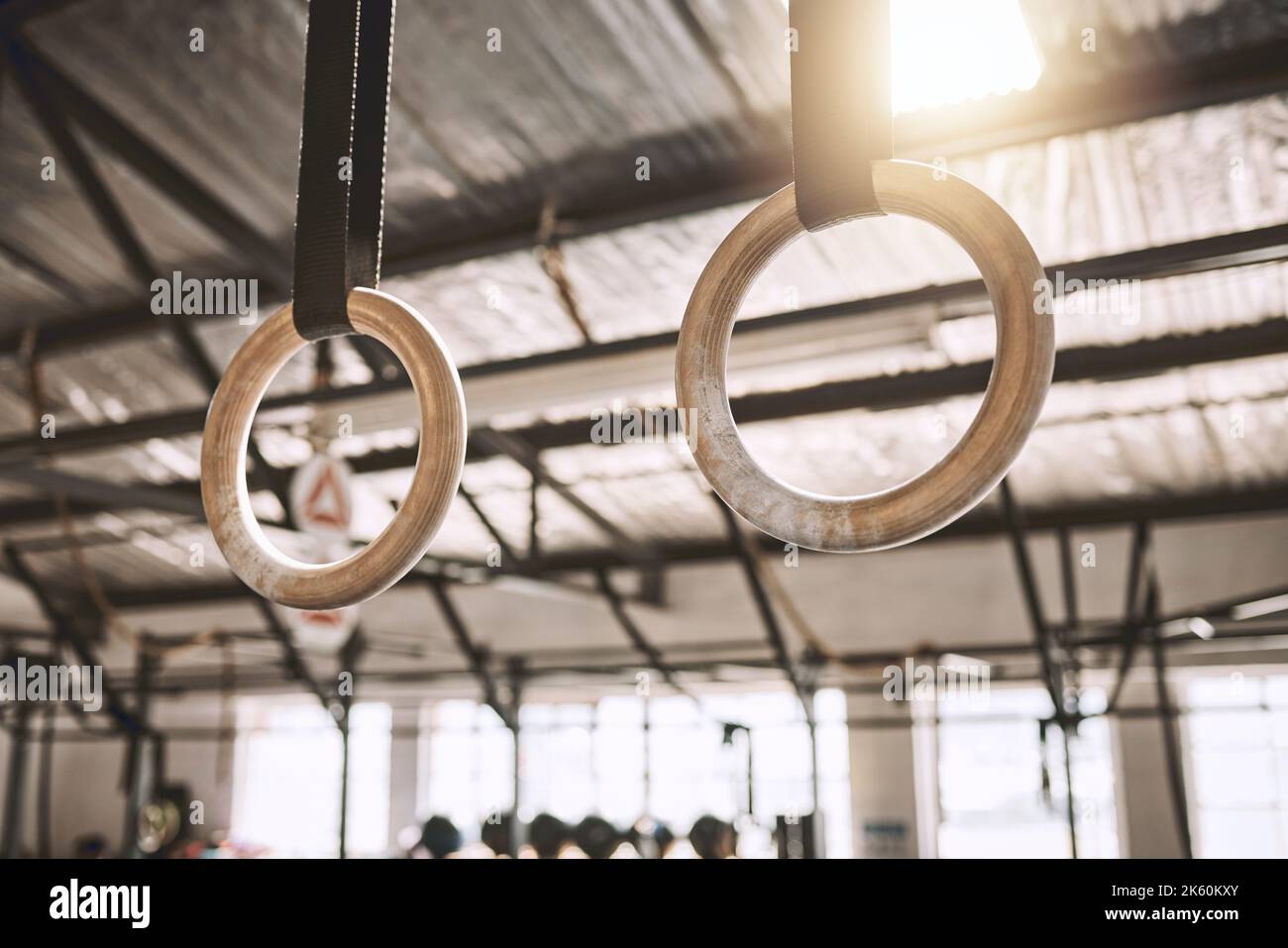 Gymnastic rings hanging in a gym. Empty gym with workout equipment ...