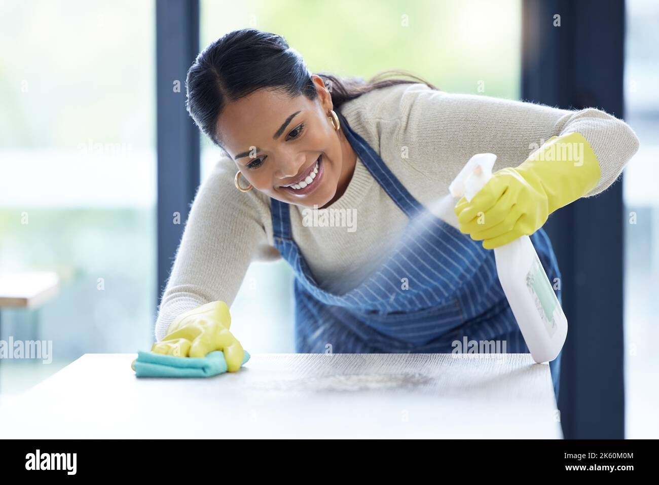 Woman spring cleaning table furniture with spray product, cloth and ...