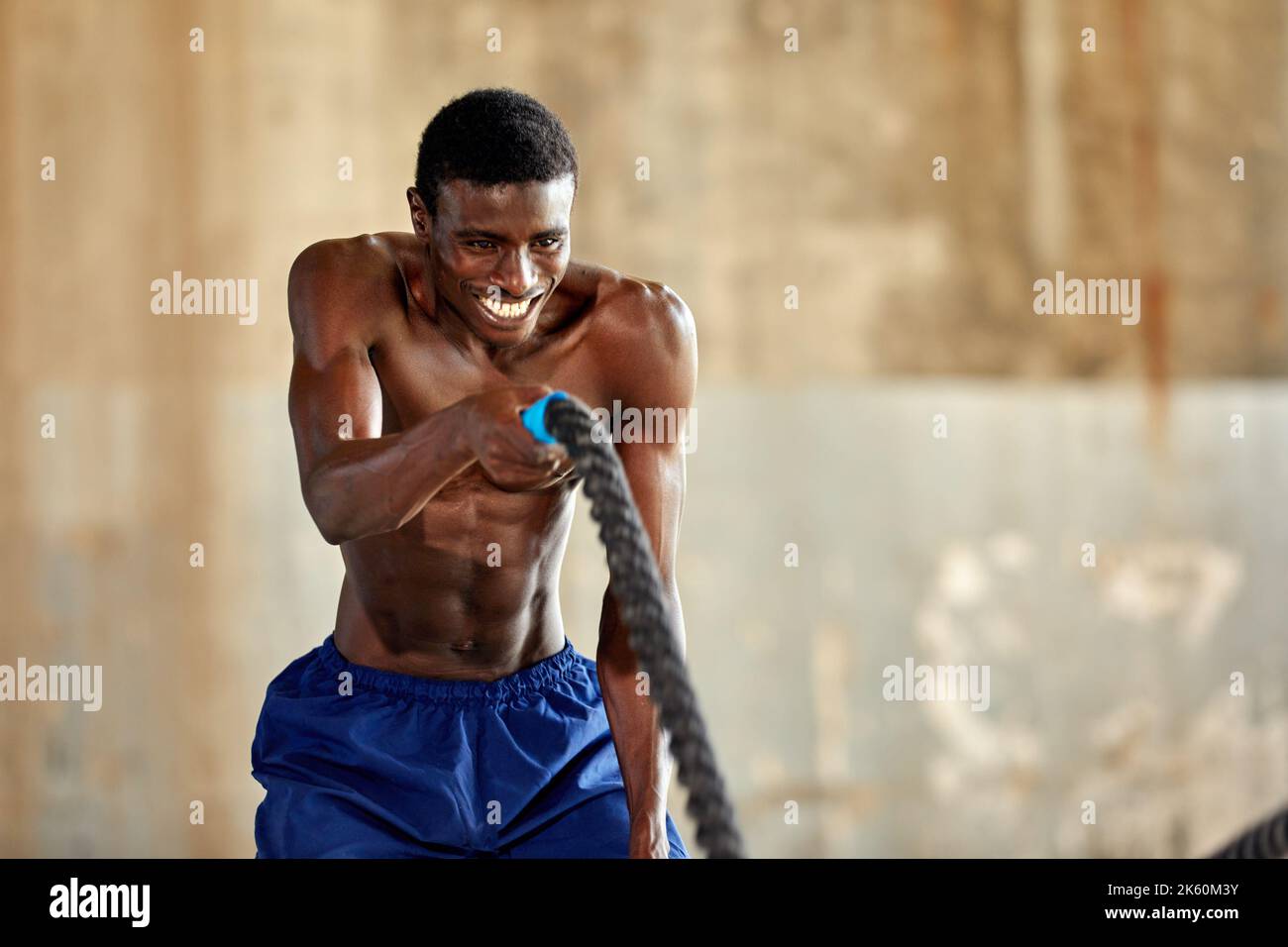 Sportsman doing heavy rope training hi-res stock photography and images ...