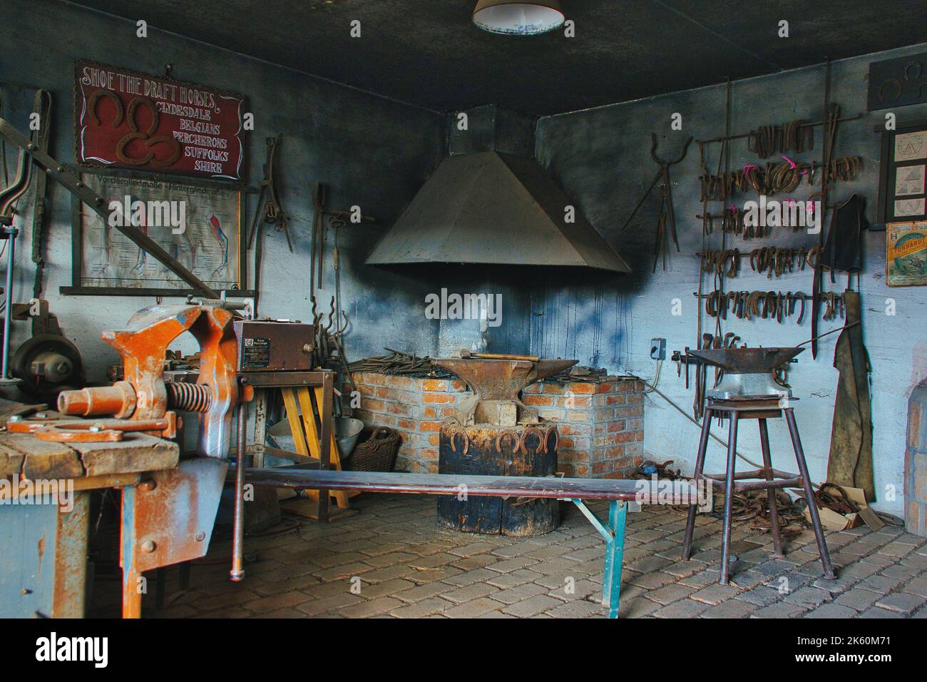 An interior of a small smithy with tools and a bench Stock Photo - Alamy