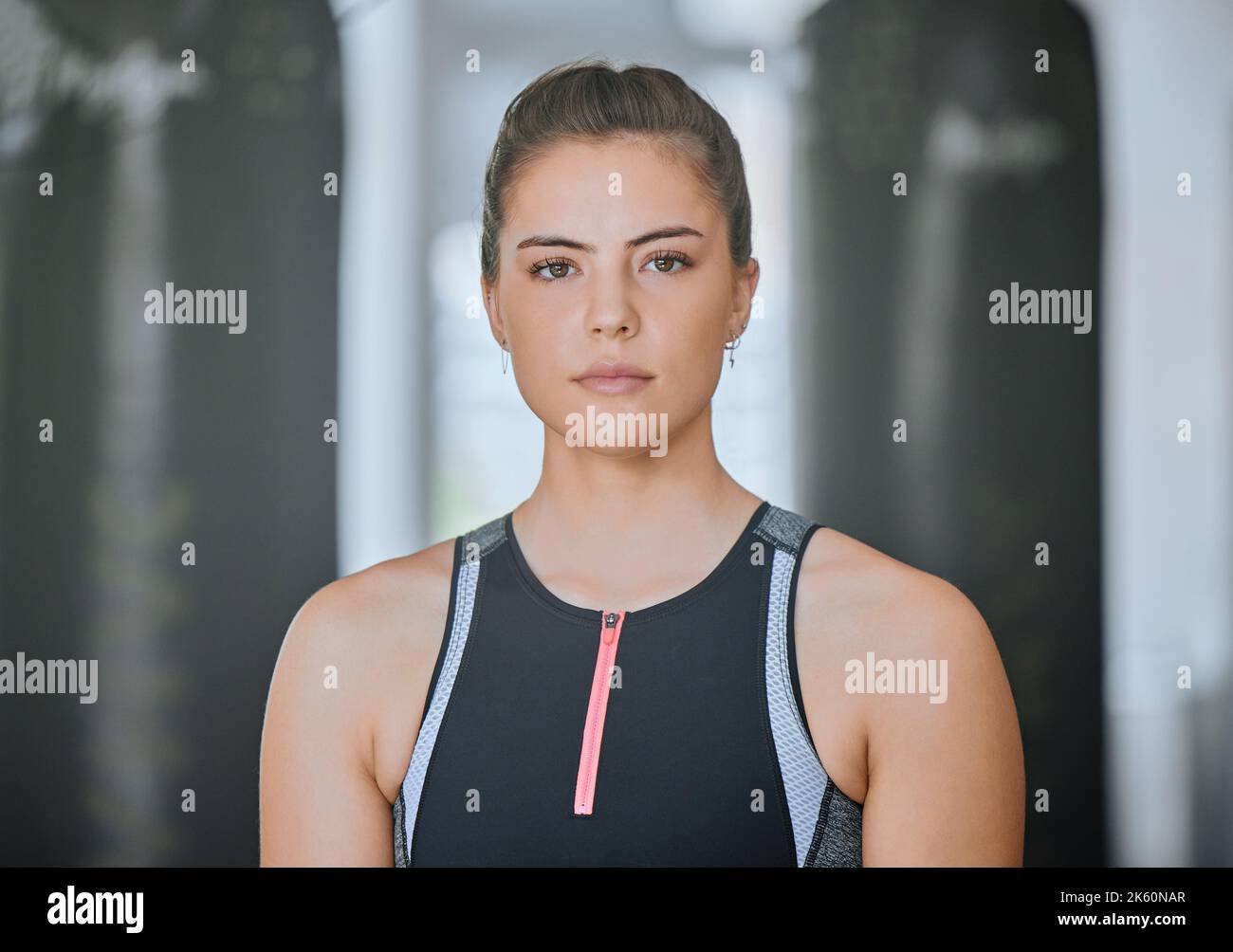Portrait of one serious woman alone in gym. Beautiful ambitious focused ...