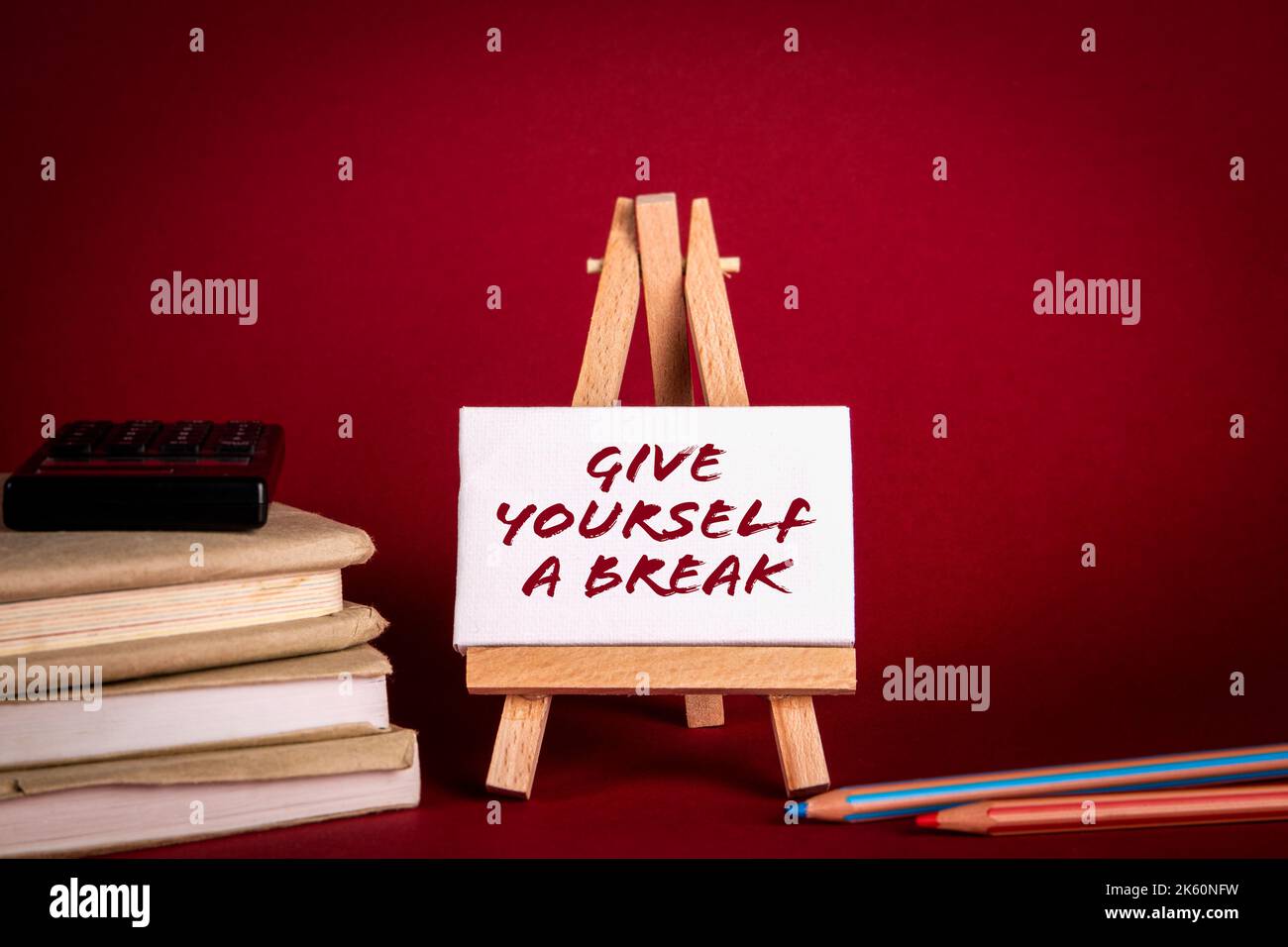 Give yourself a break. Miniature easel with text on a red background ...