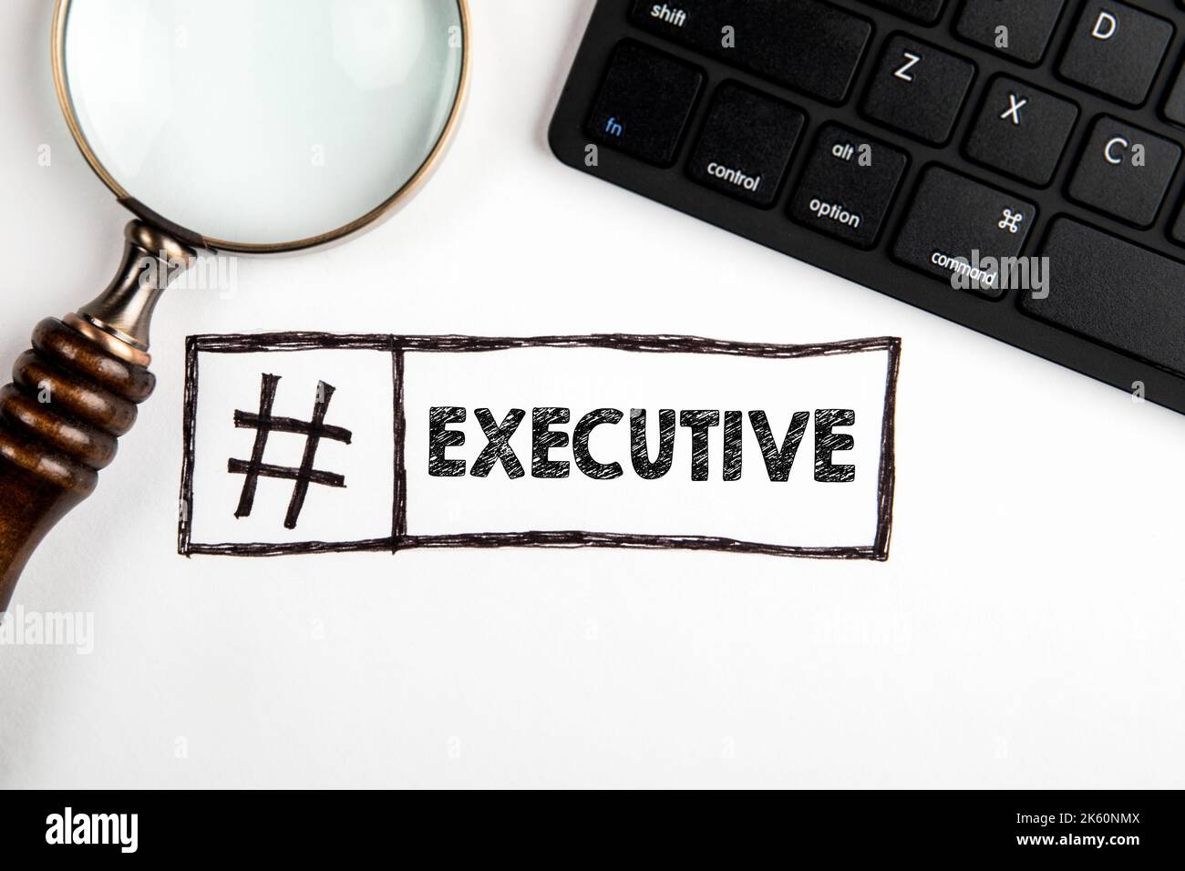 Executive. Computer keyboard and magnifying glass on the office table ...
